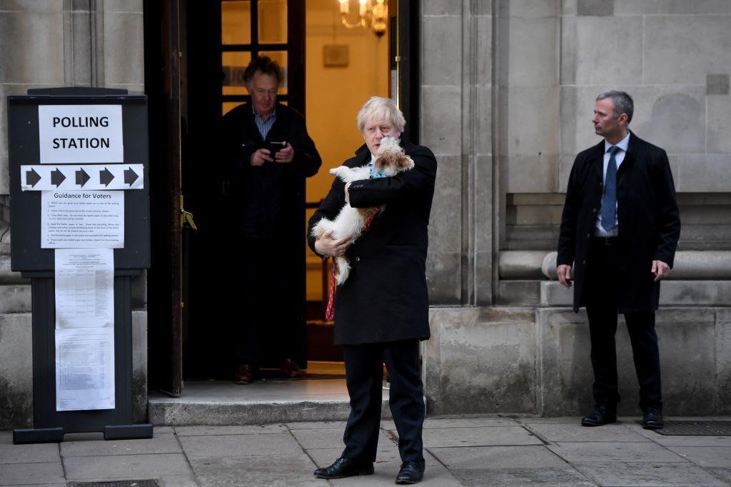 UK PM Boris Johnson arrives with his dog Dilyn to cast his vote