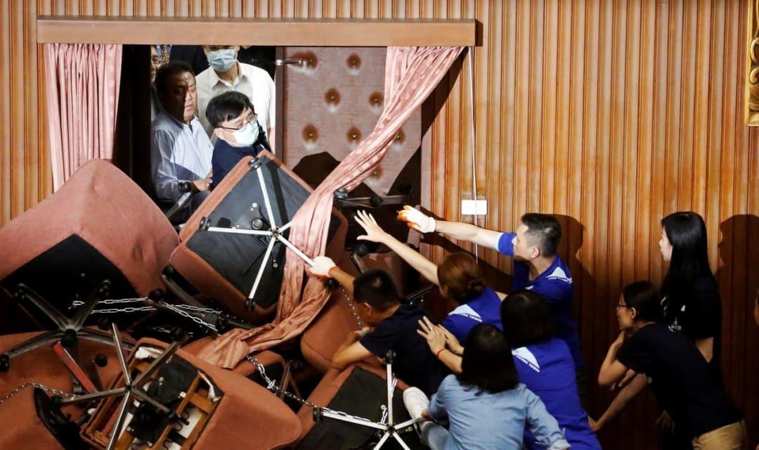 Taiwanese lawmakers fight in parliament after opposition occupies it ...