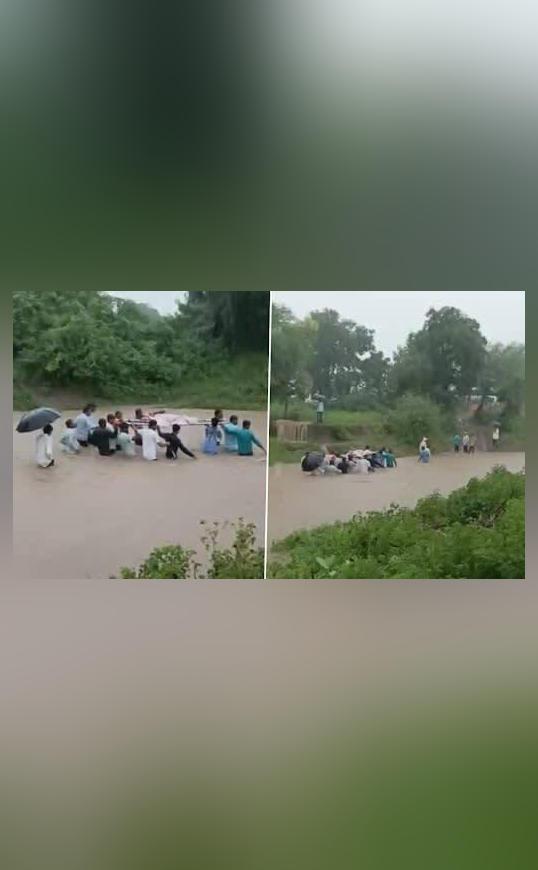 Video shows people carrying dead body through flood water in Maha ...