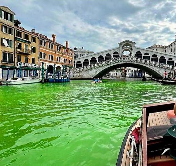 Water in Venice's iconic Grand Canal mysteriously turns bright green ...