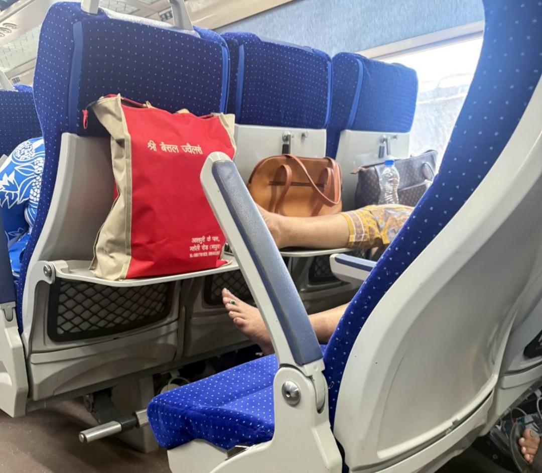 Pic shows woman resting her leg on tray table during train journey ...